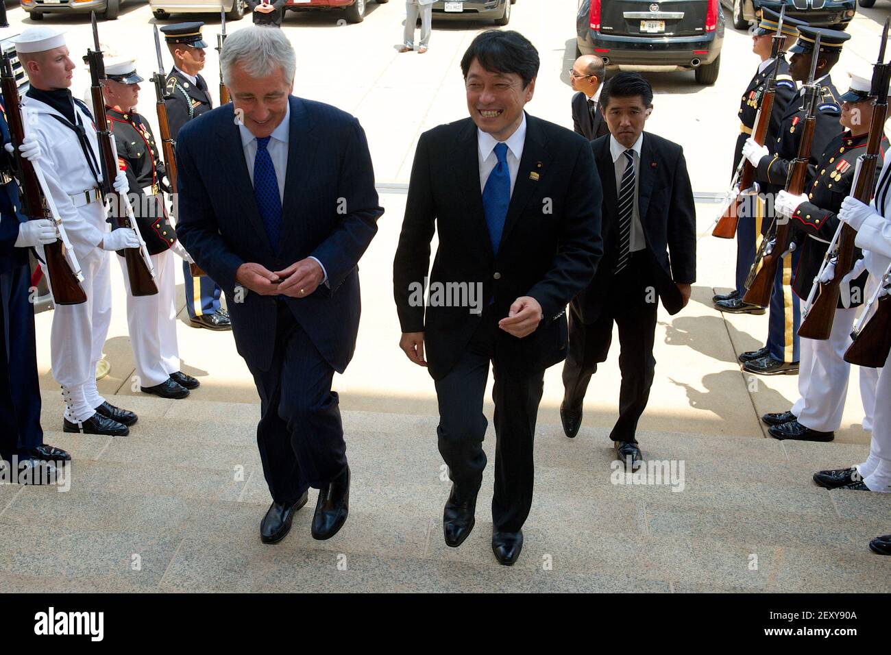 Secretary of Defense Chuck Hagel walks with Japan's Minister of Defense ...