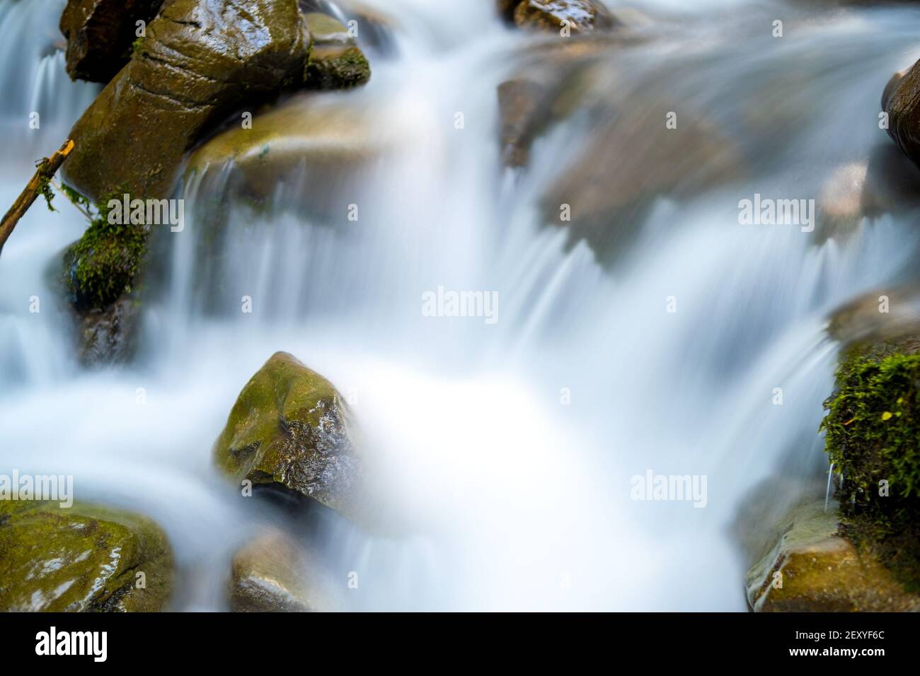 Mountain river with small waterfall with clear turquoise water falling ...