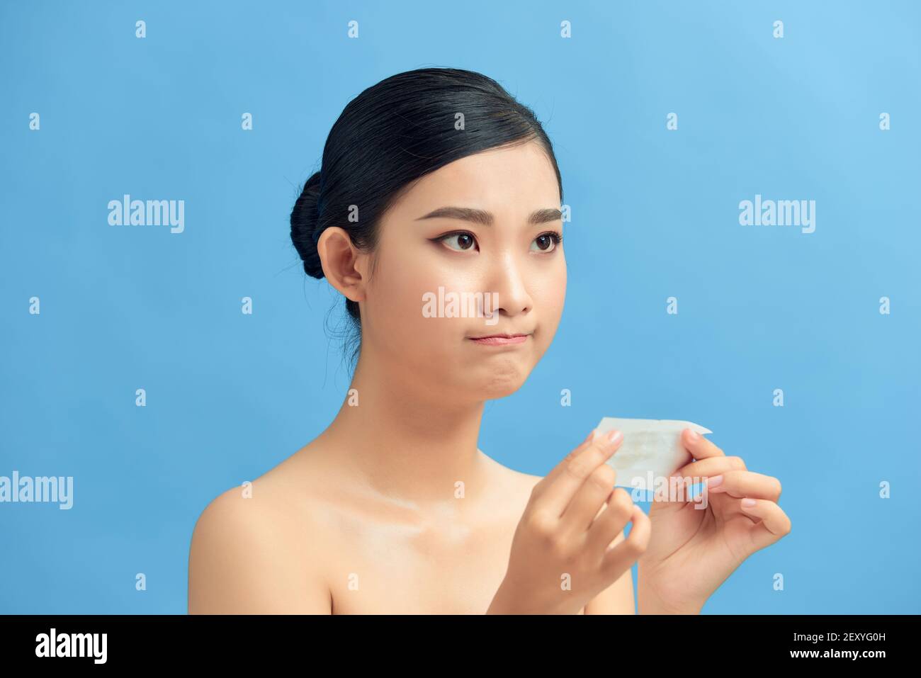 Young asian skin care woman upset after use oil blotting paper on her ...