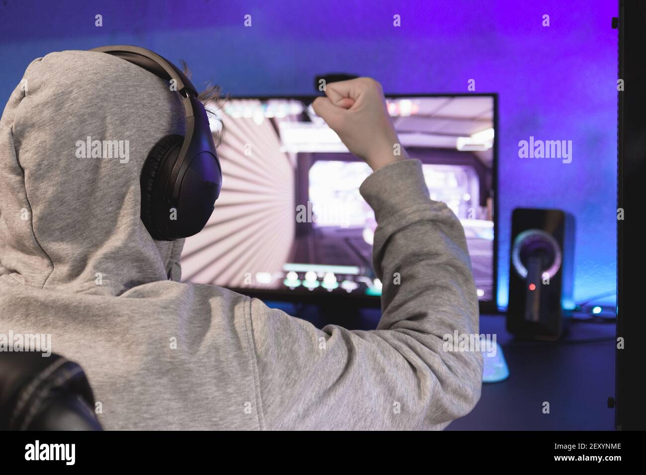 Professional gamer playing and winning first person online video game ...