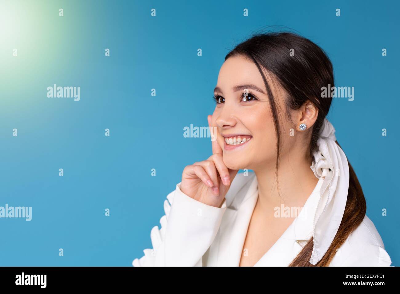 Smiling young female employee look in distance thinking or visualizing ...