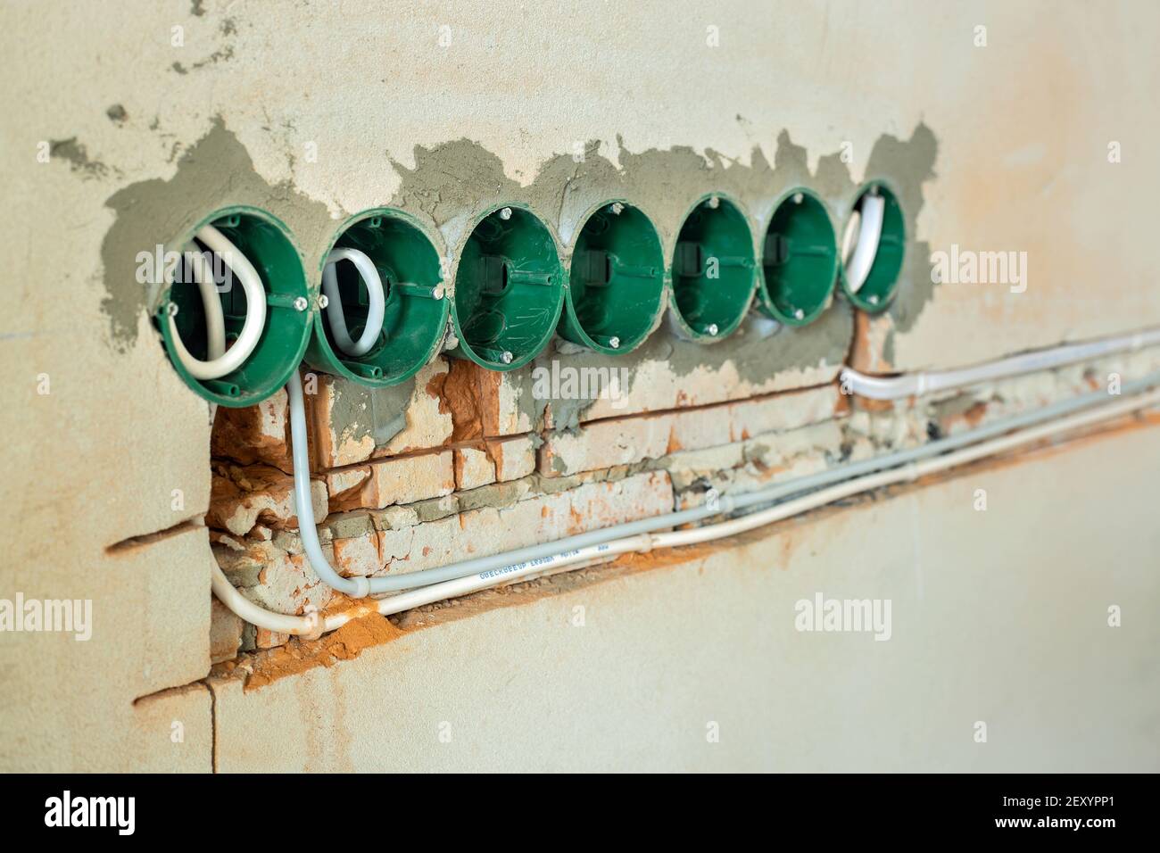 New electrical wiring installation, plastic boxes and electrical cables ...