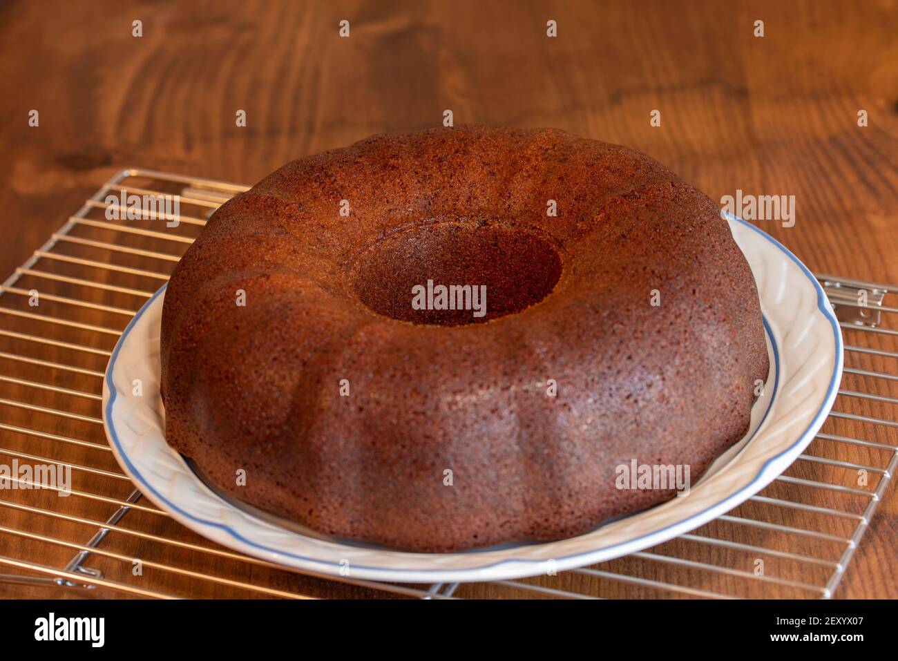 delicious crown-shaped chocolate sponge cake cooling on a wire rack ...