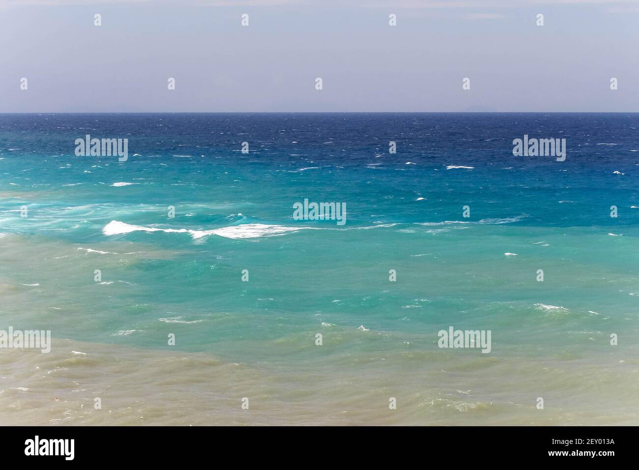 blue and turquoise ocean with waves in calabria Stock Photo - Alamy