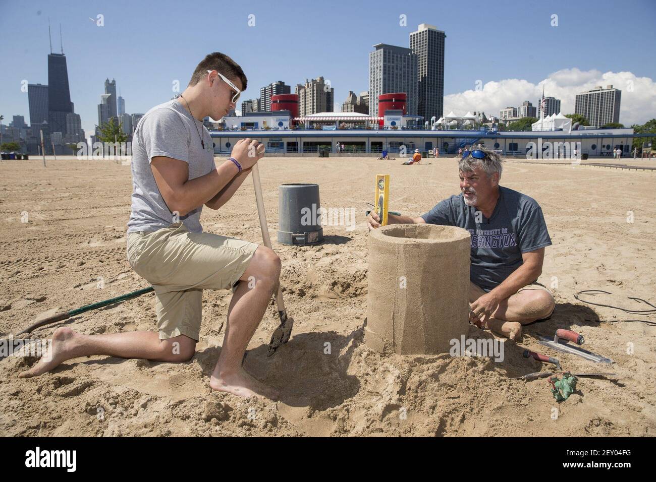 Ted Sieber, right, and his son Gus Sieber, 17, form the outer walls ...