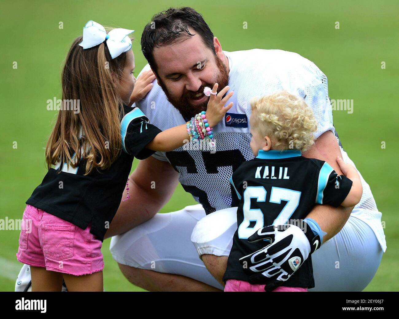 Kennadi Kalil, 4, and Chandler Kalil, 2, reach out to hug their father ...
