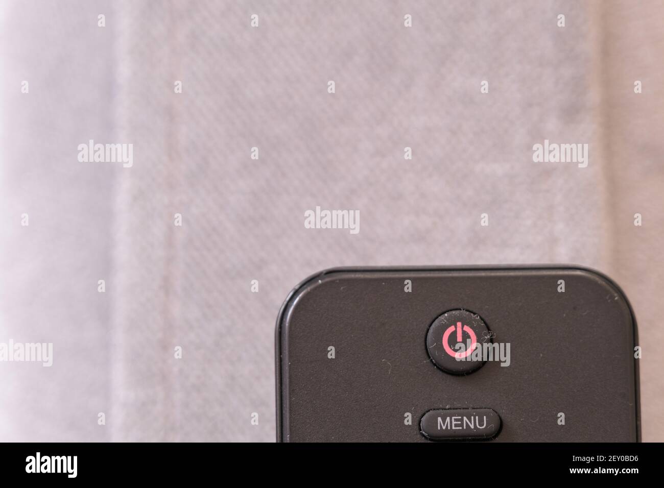 Off button on TV commander and its standing on armrest of single seat ...