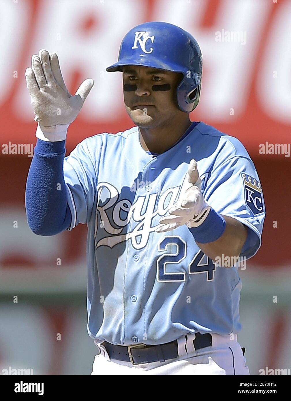 The Kansas City Royals' Christian Colon applauds after hitting a double ...