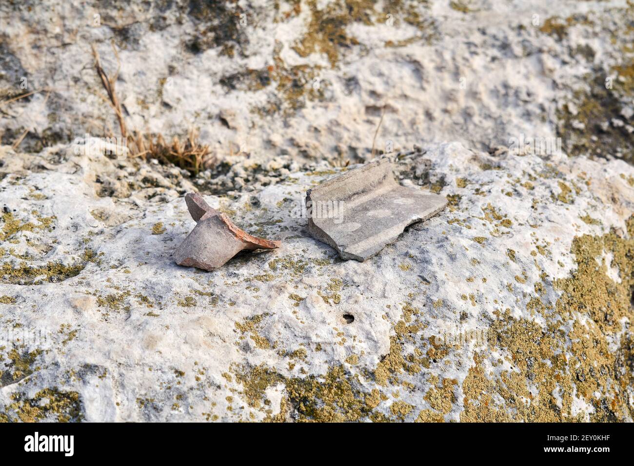 two fragments of ancient pottery lie among the stones Stock Photo - Alamy