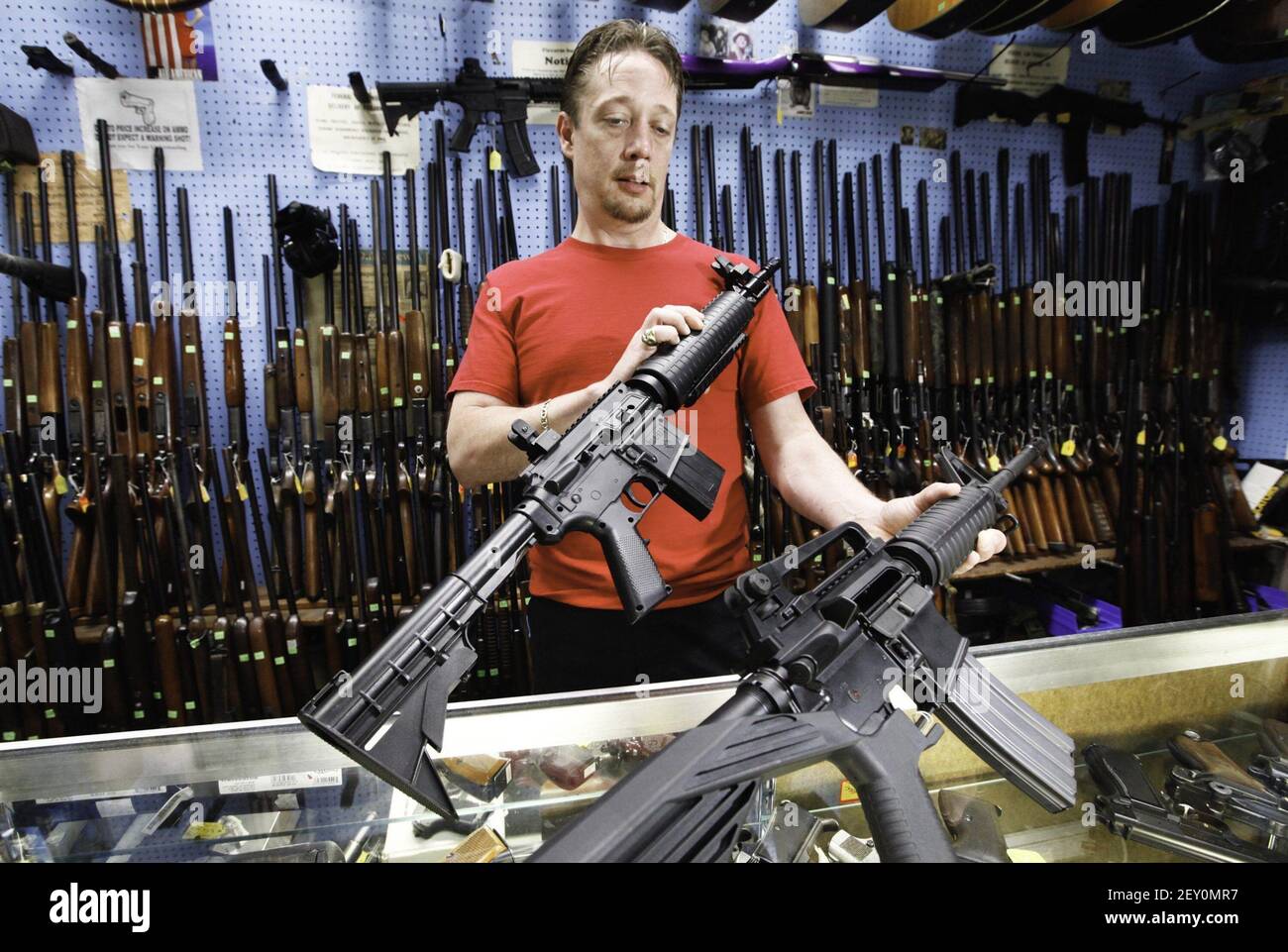 Shawn Bertke, manager of Rich's Pawn Shop in Dayton, Ohio, has two guns ...