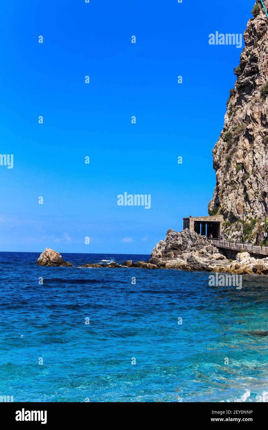 rocks in mediterranean sea with street and tunnel Stock Photo - Alamy