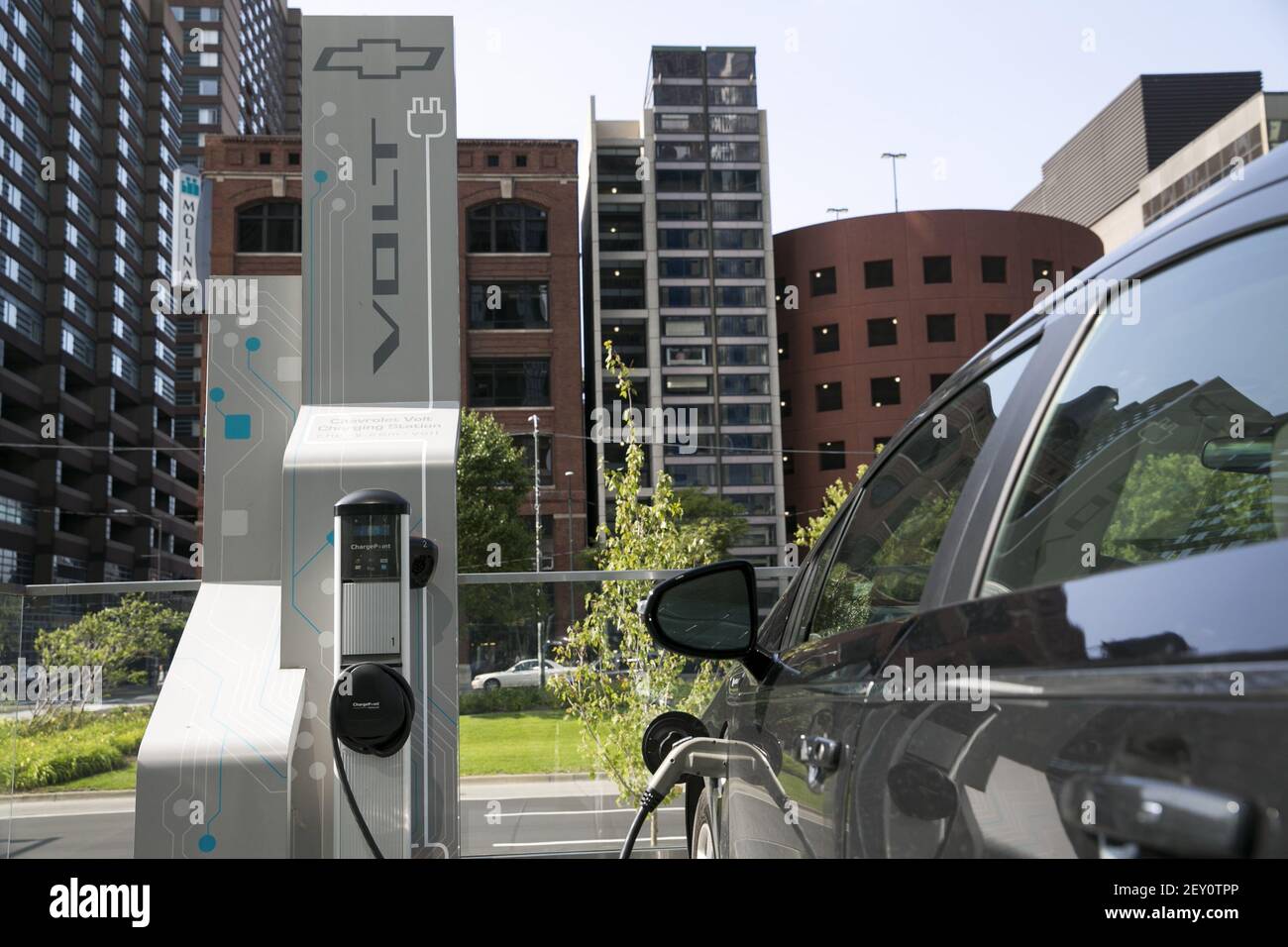 A Chevy Volt electric car charging outside of the headquarters of the ...
