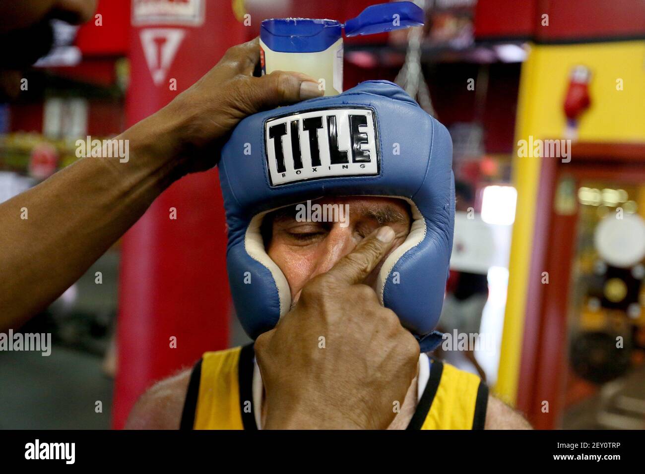Coach Stacy McKinley applies vaseline to Rick Picone's face before his ...