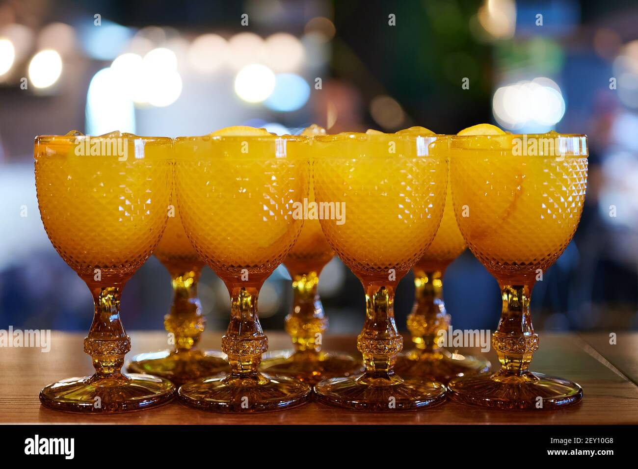 Yellow alcoholic cocktail in beautiful glass medieval glasses with ...