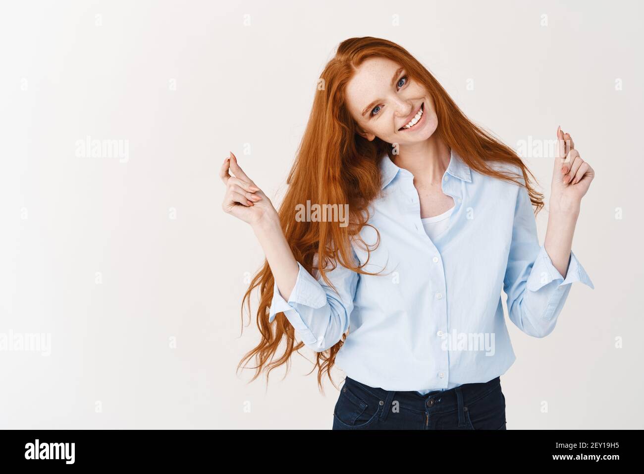 Image of beautiful girl with ginger hair and blue eyes snap fingers and ...