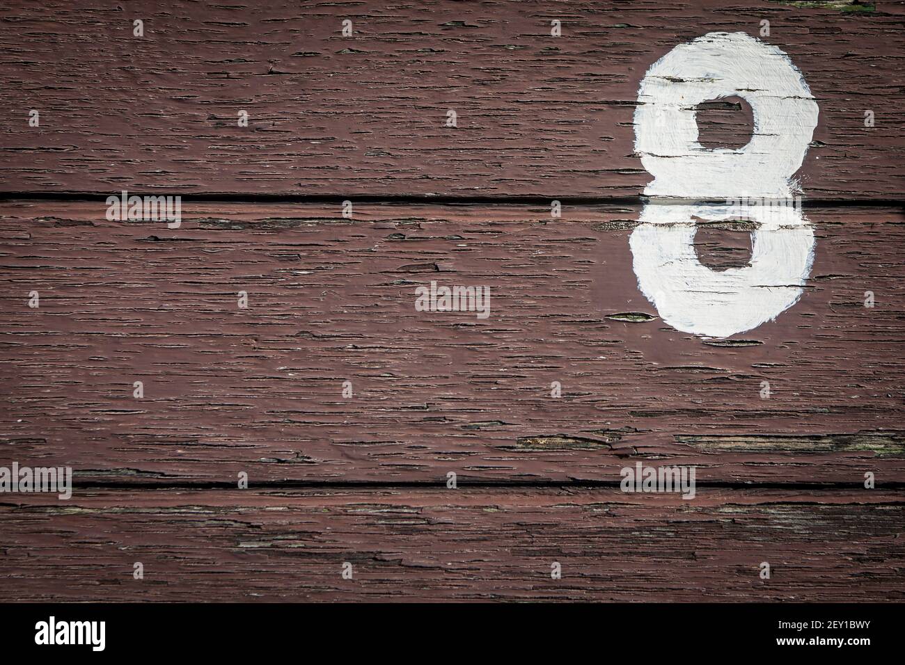 A brown door with the number eight on it Stock Photo - Alamy