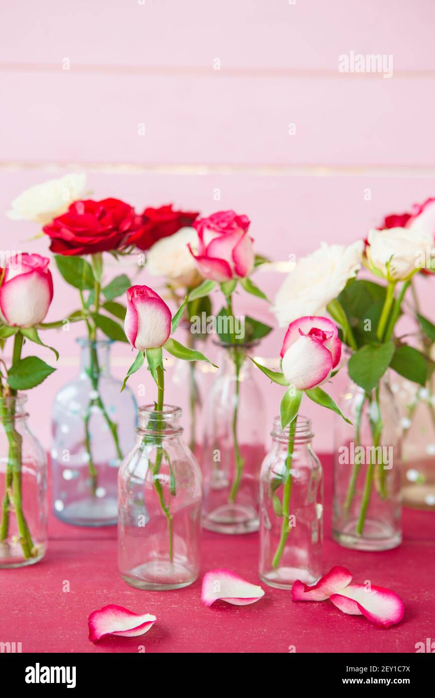Fresh roses in small bottles Stock Photo - Alamy