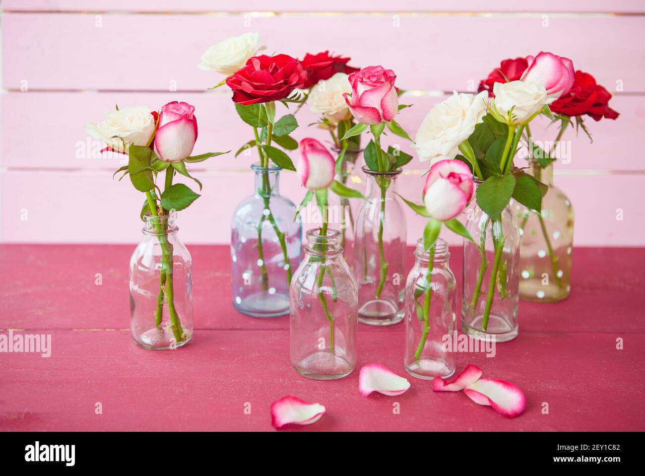 Fresh roses in small bottles Stock Photo - Alamy