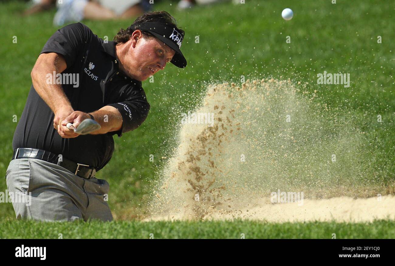 Phil Mickelson hits out of a sand trap on the 15th hole during the ...