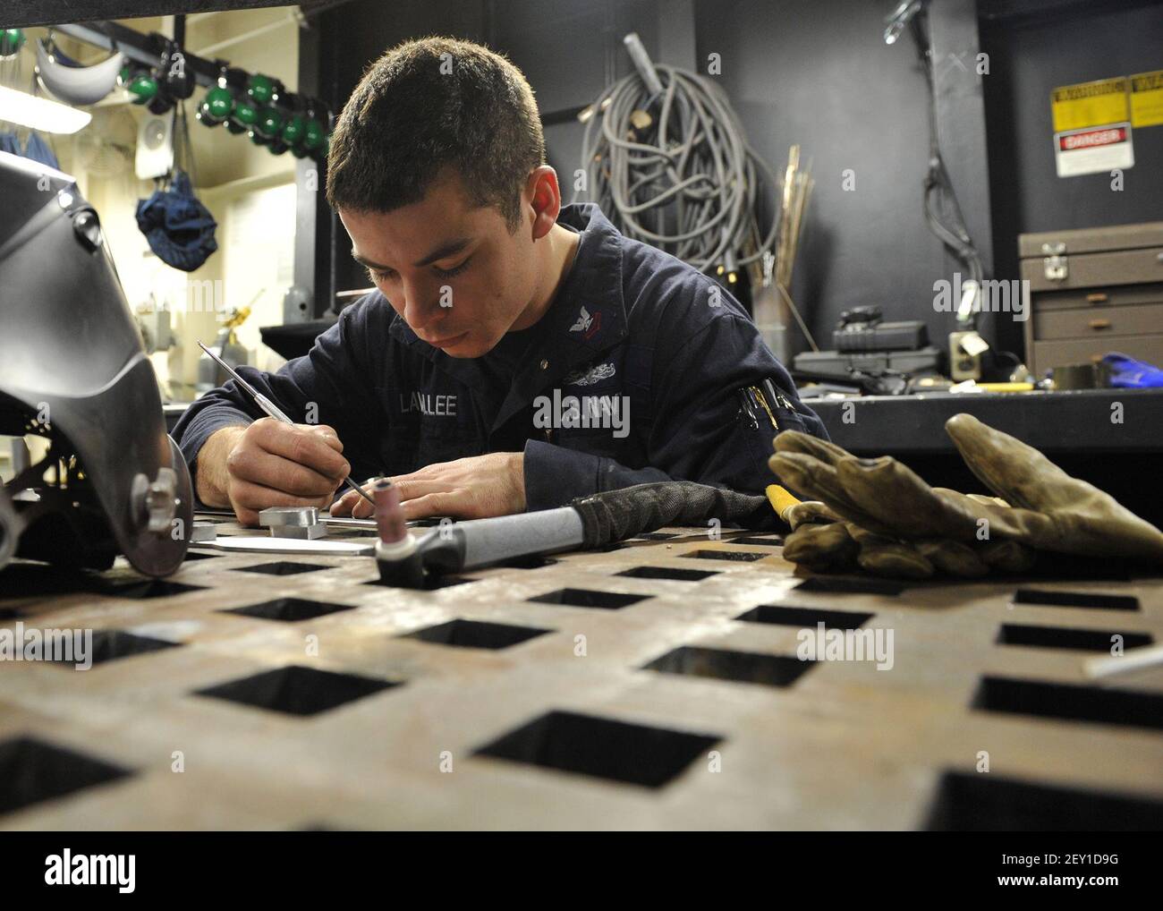 U.S. Navy Hull Maintenance Technician 2nd Class Courtney Lavallee uses ...