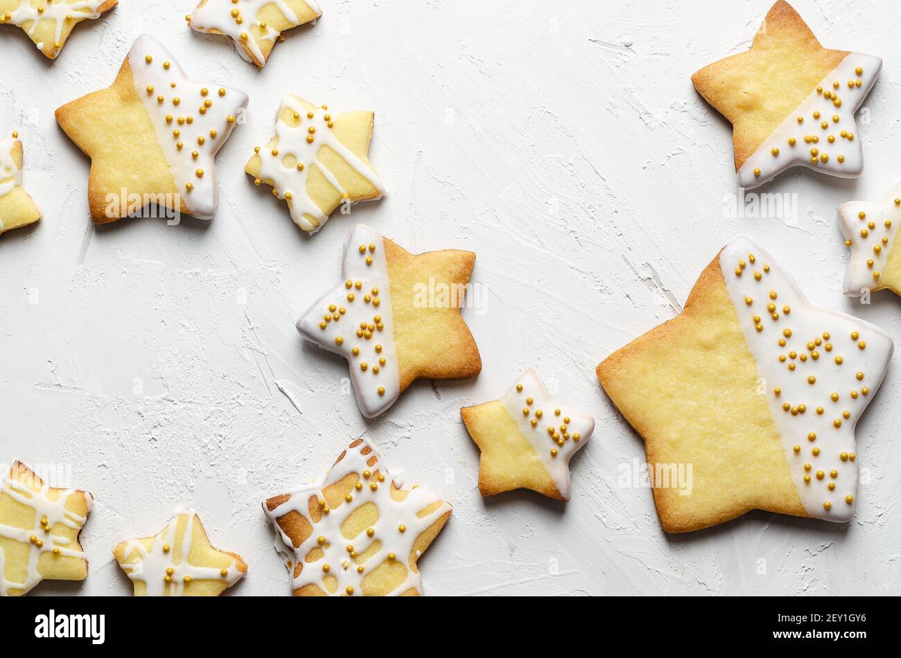 Star iced cookies with golden pearls, on a white backdrop Stock Photo ...