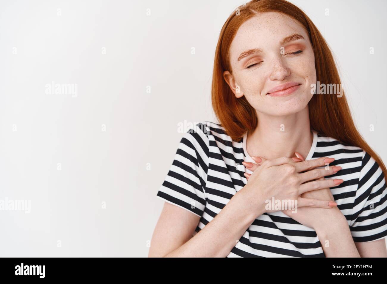 Romantic girl with red hair and freckles dreaming about something ...