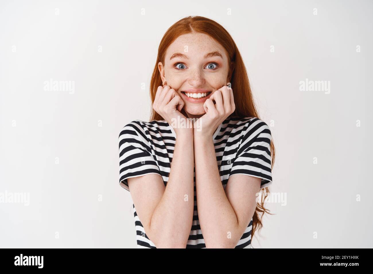 Image of extremely happy and surprised young woman with red hair ...