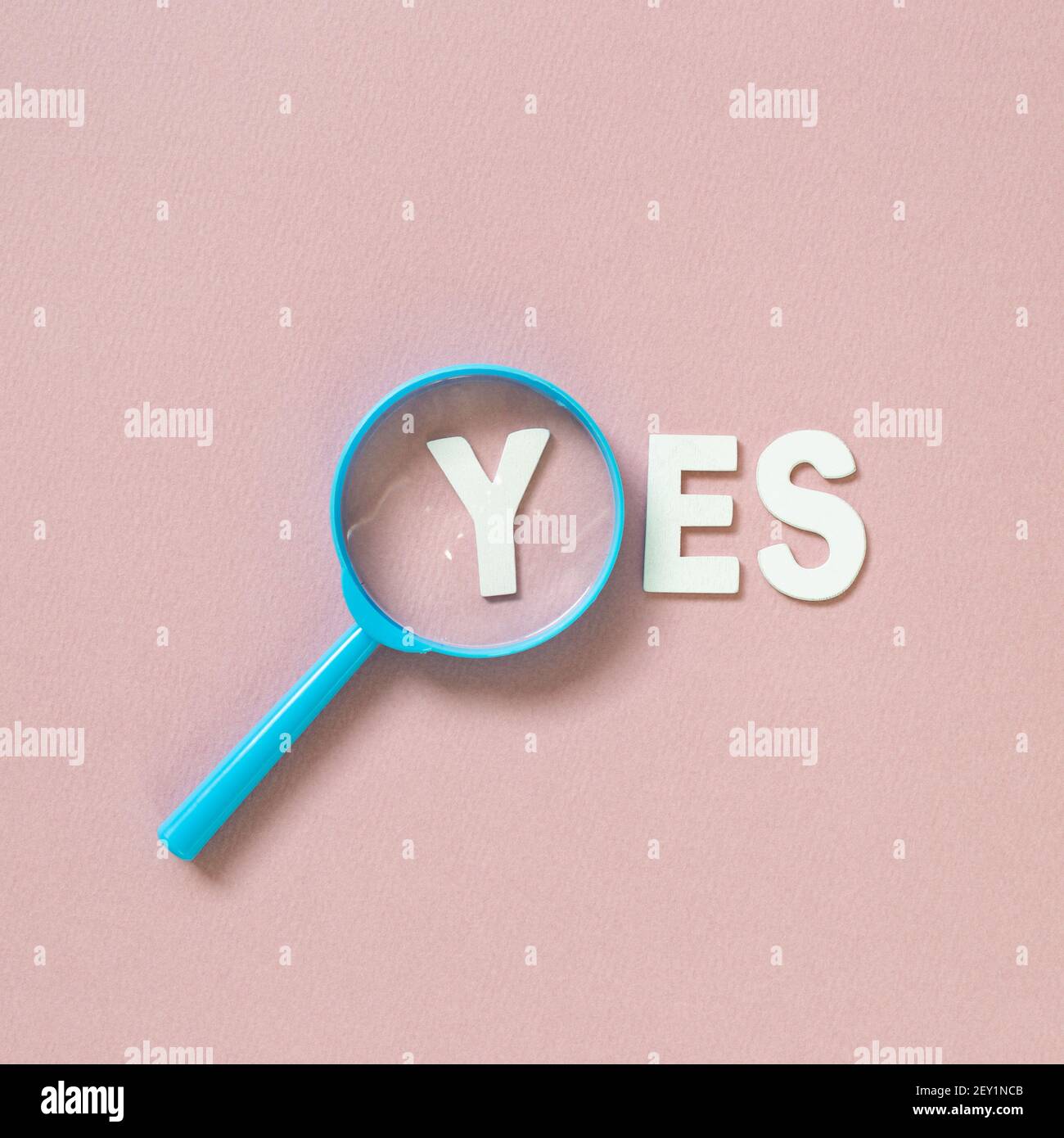 Word 'YES' and magnifying glass on pink background. top view Stock ...