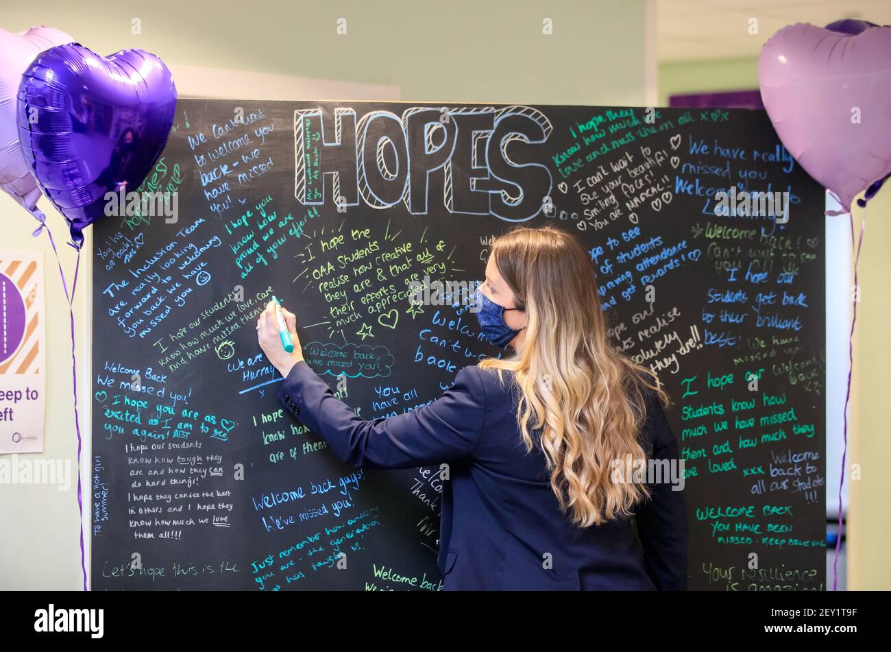 Associate vice principal Hannah Smith writing a welcome back messages ...
