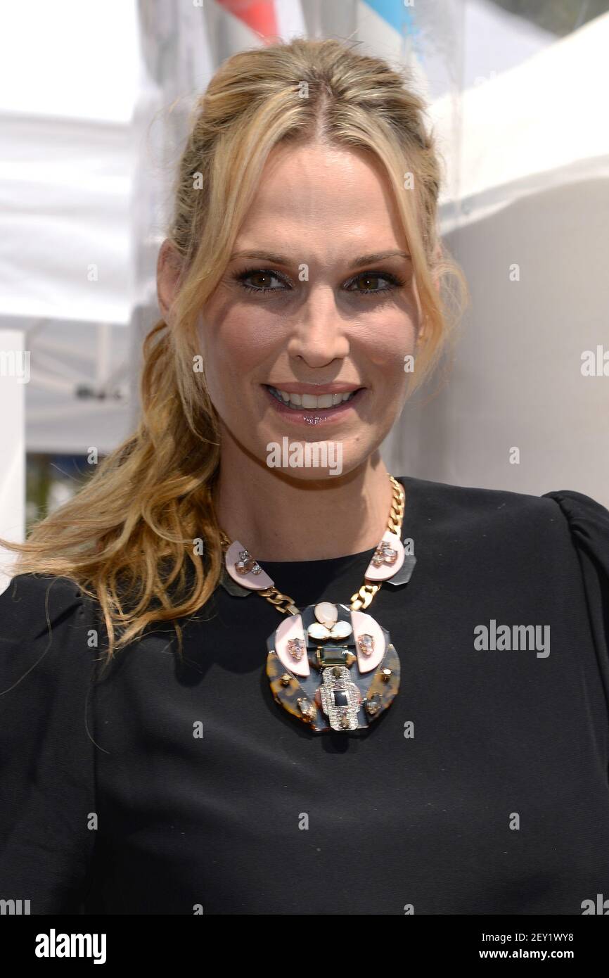 Actress and model Molly Sims poses along side a 12 ft tall glass of ...