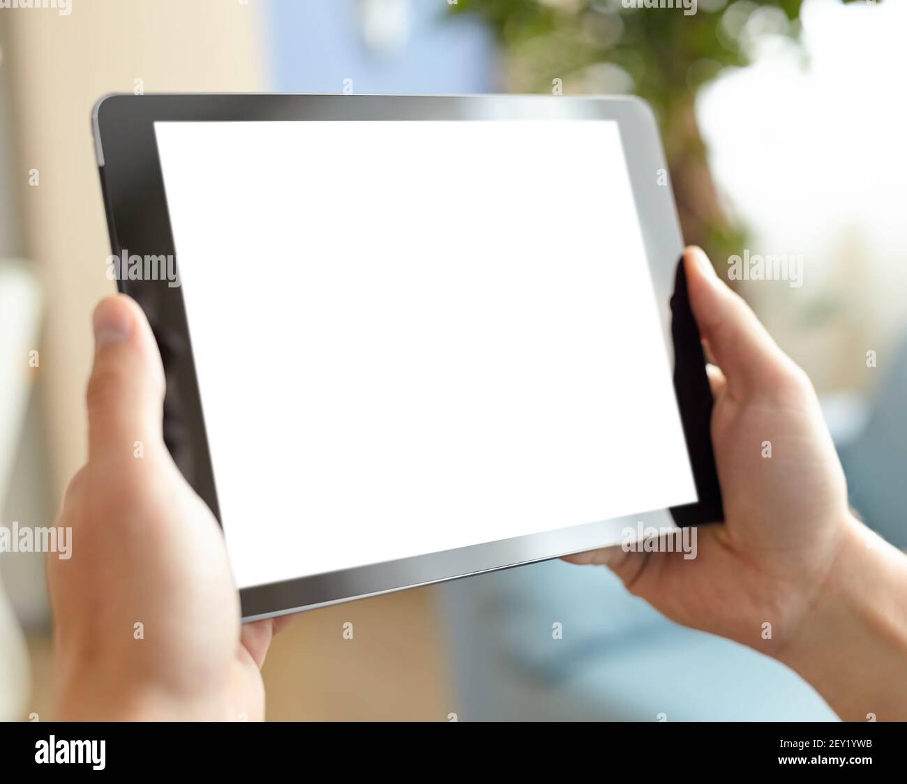 Digital tablet male hands over home background Stock Photo - Alamy