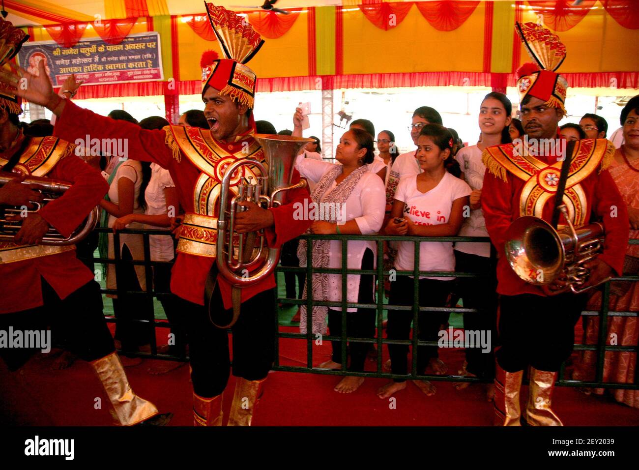 Band players gesture in a religious procession during the "Ganesh ...