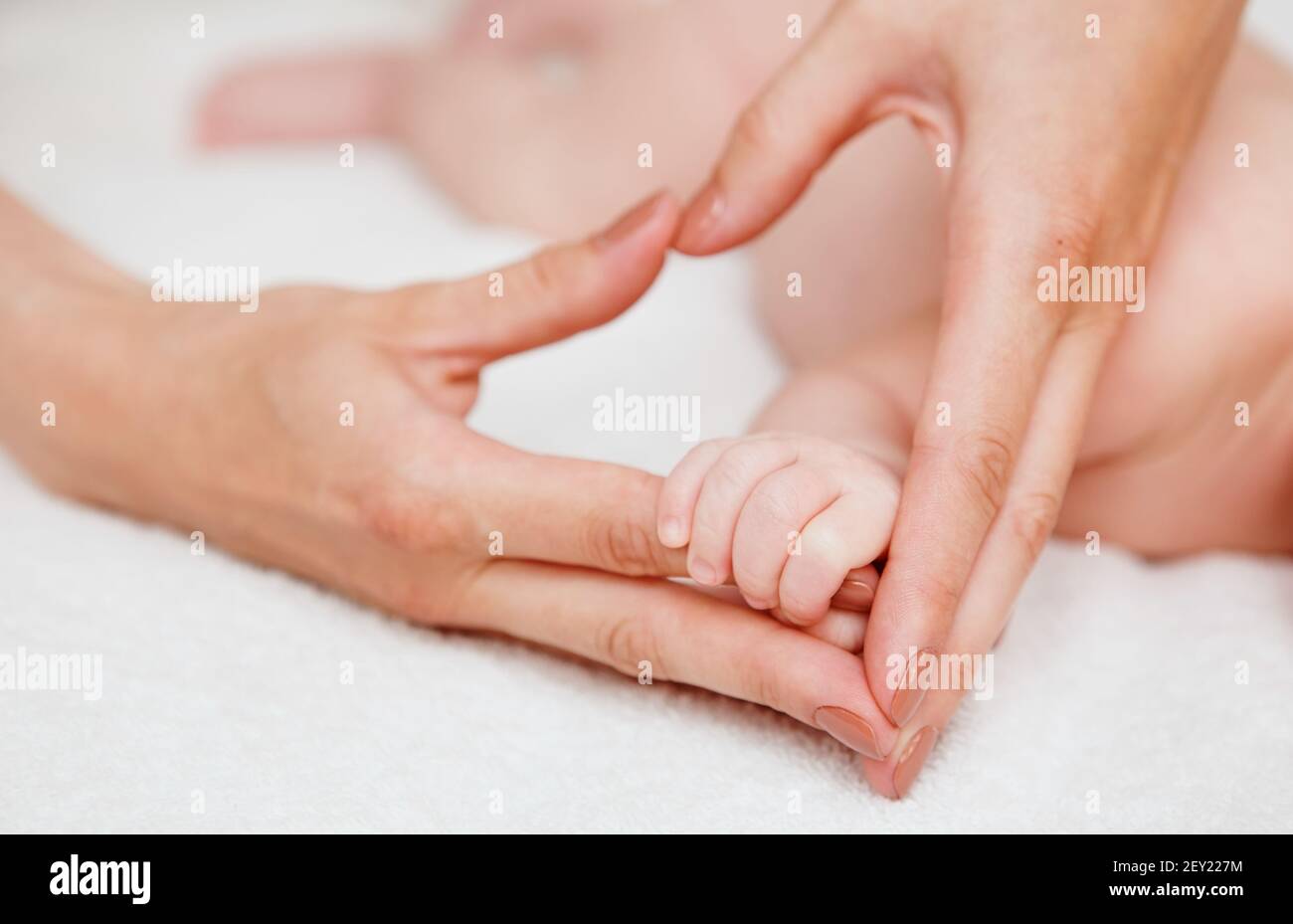 Baby hand holding mother finger hi-res stock photography and images - Alamy