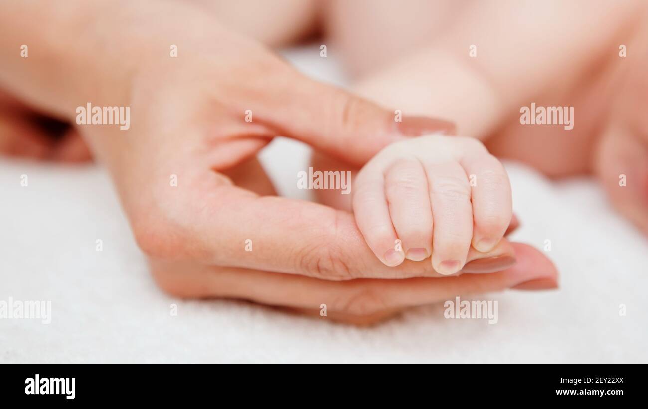 Sleeping baby in hand of parent Stock Photo - Alamy