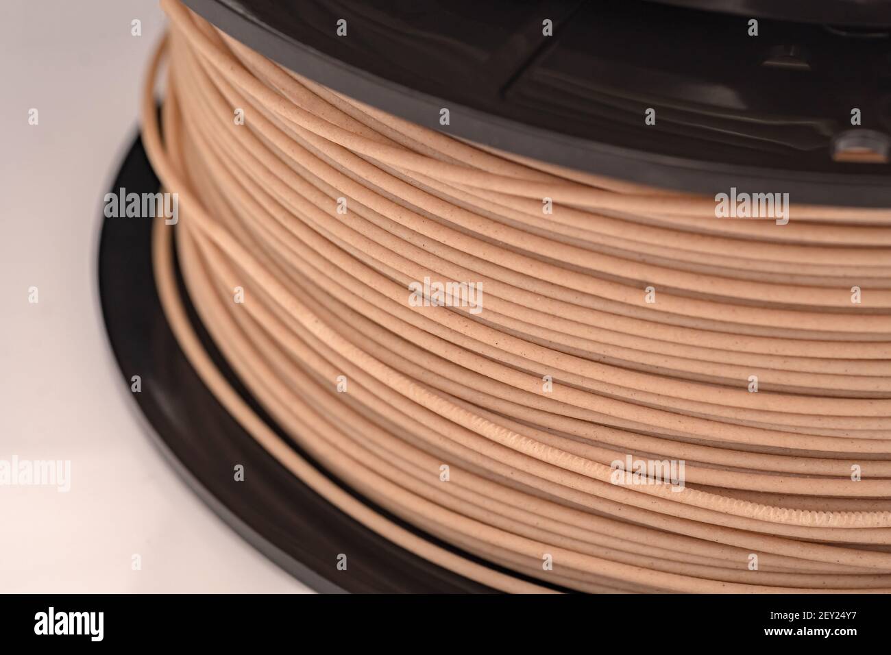 Spool of PLA filament for 3D Printer - wooden color Stock Photo - Alamy