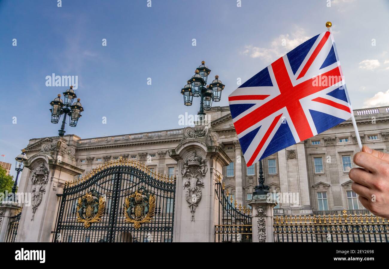 Toursist in London holding flag of Great Britain in hand. Buckingham ...