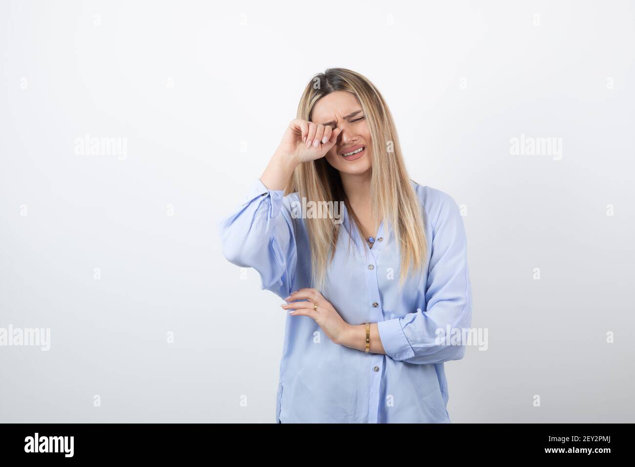 Image of young pretty woman crying on white background Stock Photo - Alamy