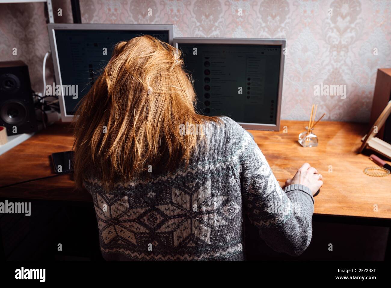 a girl is typing on a keyboard, working at a personal computer from ...