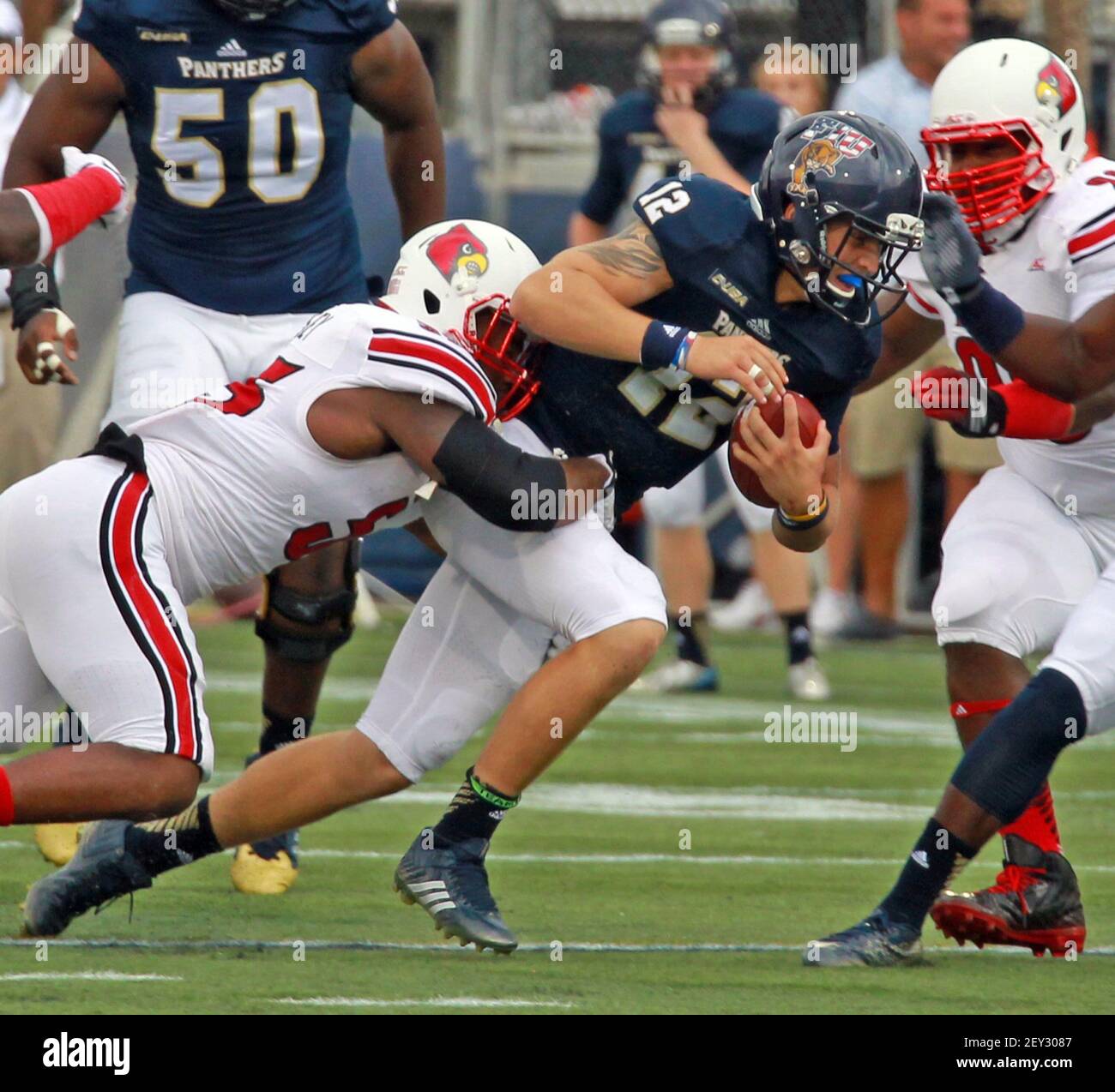 Florida International quarterback Alex McGough (12) is pulled down by ...