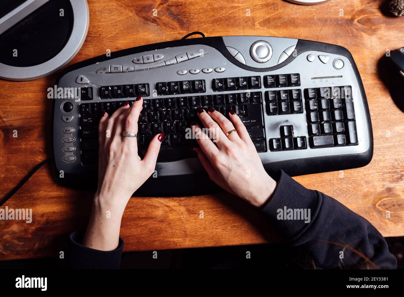 a girl is typing on a keyboard, working at a personal computer from ...