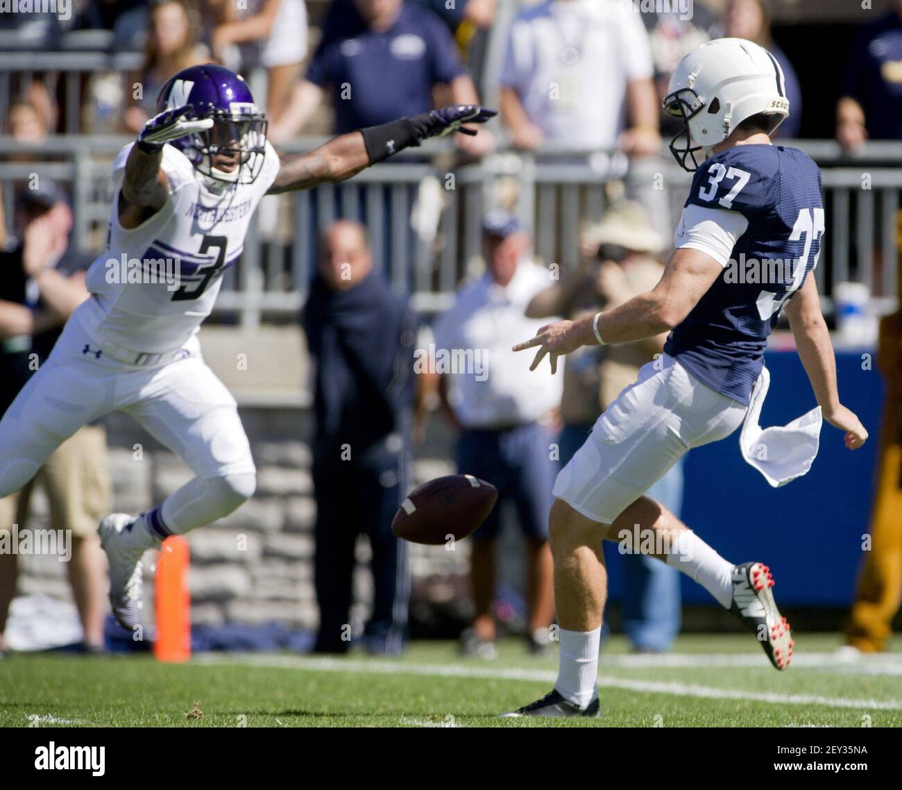 Penn State's Chris Gulla (37) punts as Northwestern's Keith Watkins II ...