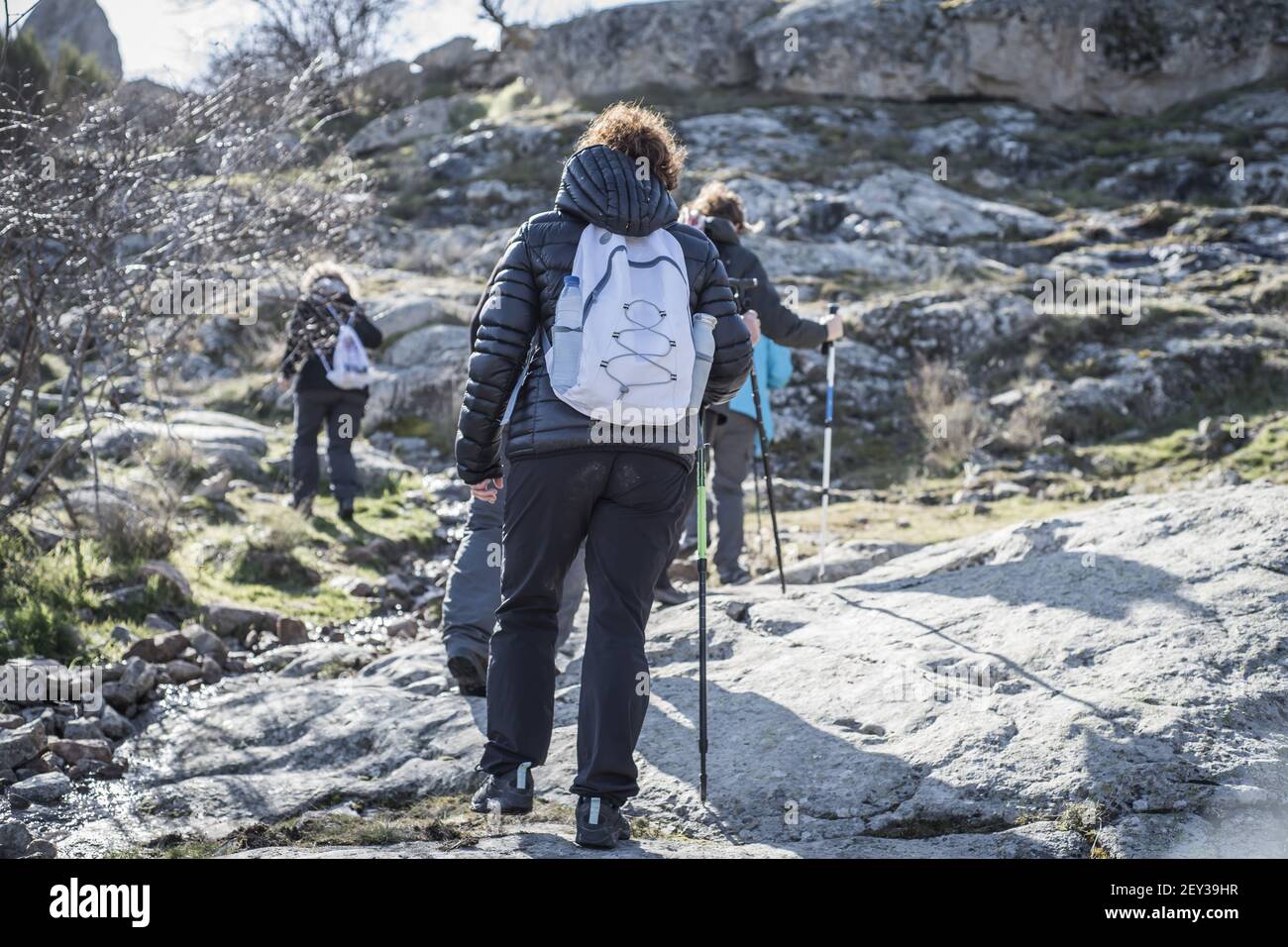 A group of people with backpacks on the hiking trail in Riofrio, Avila ...
