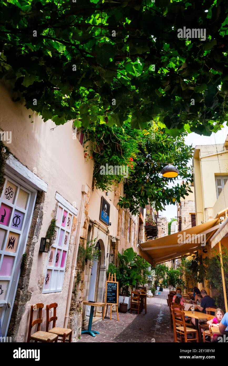 Vine covered cobblestone outdoor Greek cafe in Chania on Crete, the ...