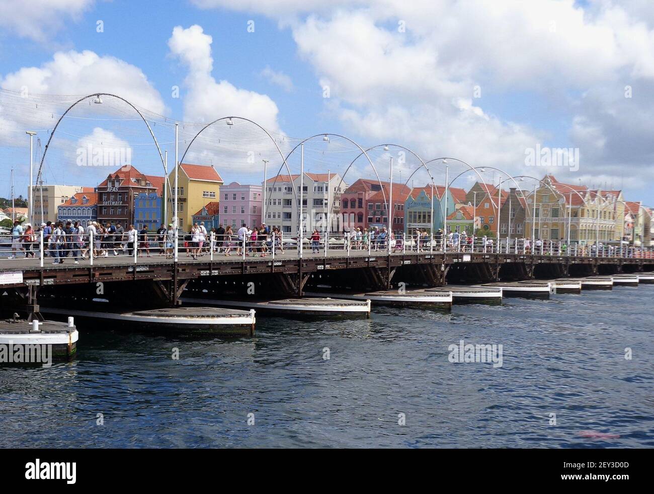 Willemstad is divided by its harbor that features a swinging bridge ...