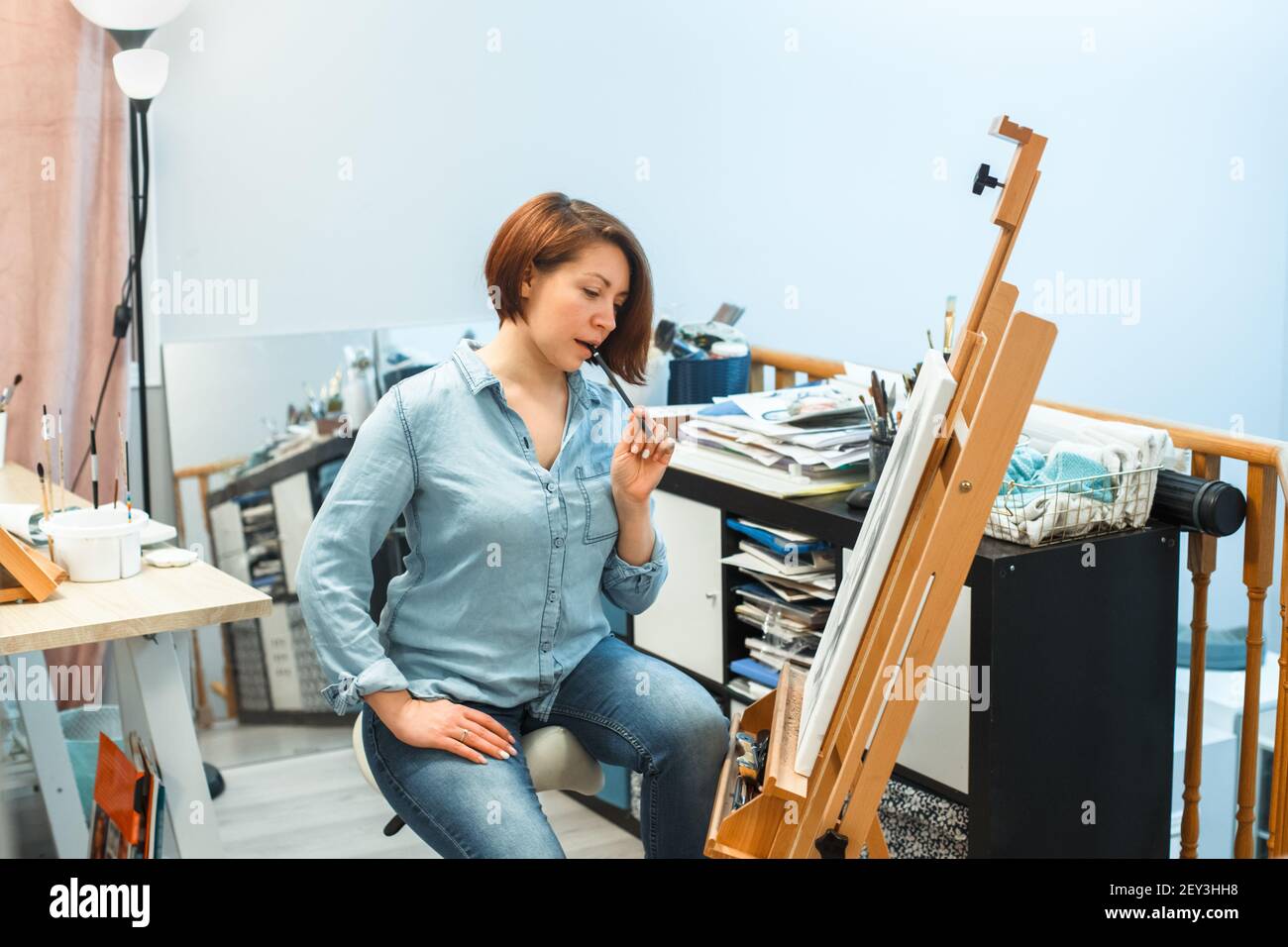 Concentrated pensive middle age Caucasian woman artist drawing with ...