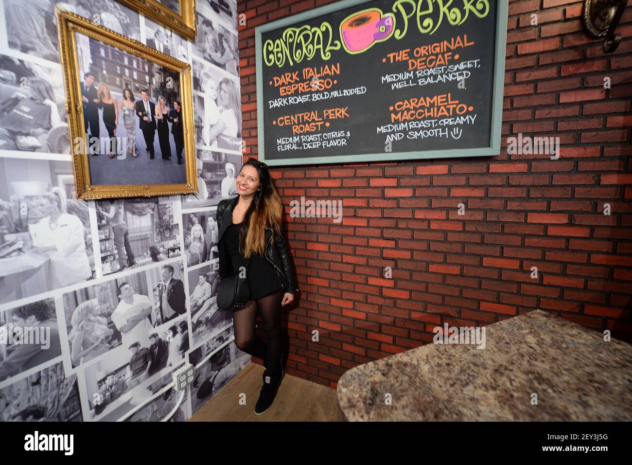 Flavia Guzman, from New York, poses under a photo of the cast of ...