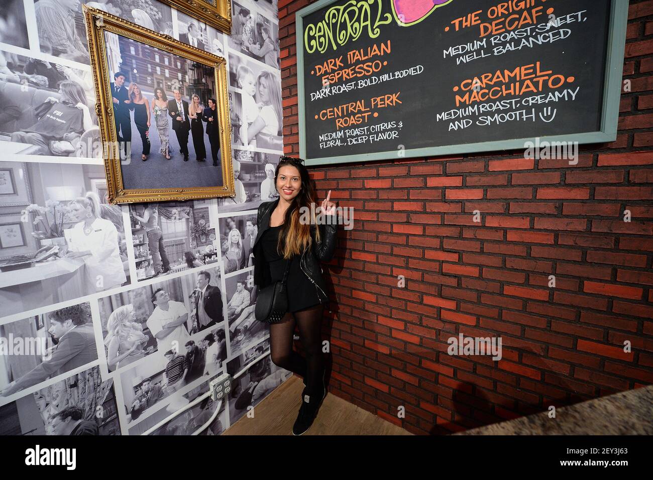 Flavia Guzman, from New York, poses under a photo of the cast of ...