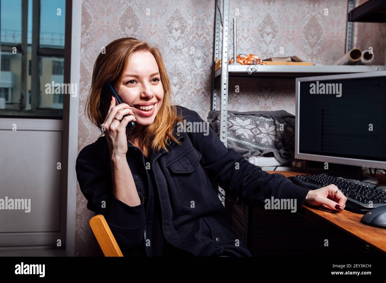 a girl is typing on a keyboard, working at a personal computer from ...