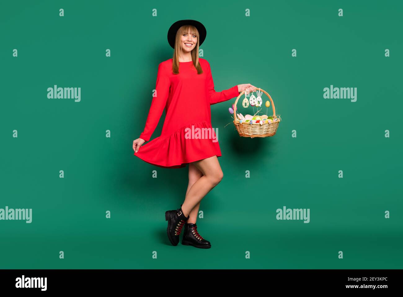 Photo of cute lady beaming smile hold easter basket wear hat red dress ...