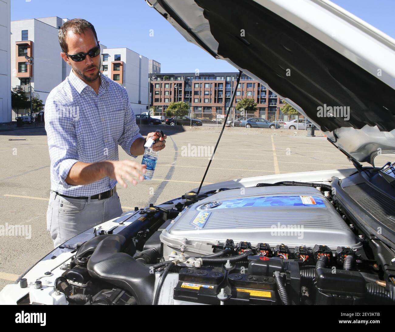 Engineer Jared Farnsworth shows off the fuel cell stack under the hood ...